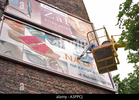 A billposter at work, Poznan, Poland Stock Photo - Alamy