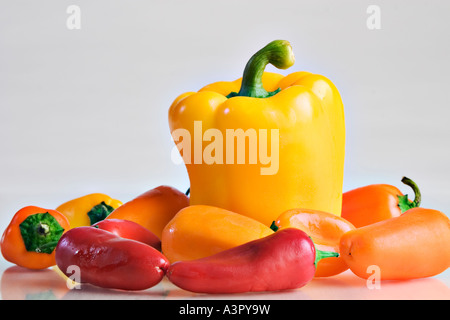 Small peppers surrounding a large bell pepper Stock Photo - Alamy