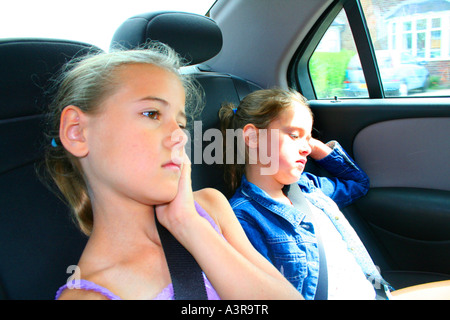 Kids bored in a car journey Stock Photo - Alamy