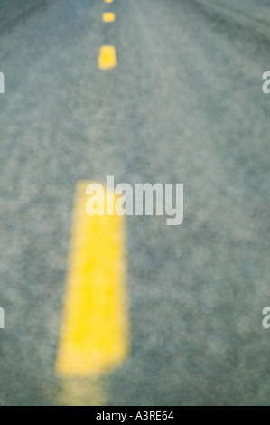 Dashed yellow line on roadway pavement close up Stock Photo - Alamy