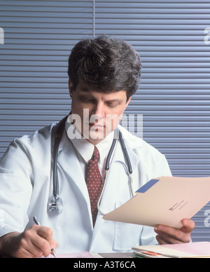 Doctor doing paperwork in her office Stock Photo - Alamy