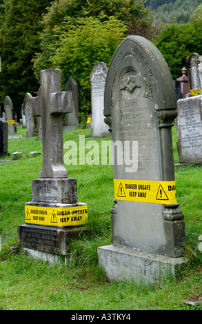 Unsafe headstones with yellow warning notices at a cemetery in Risca ...