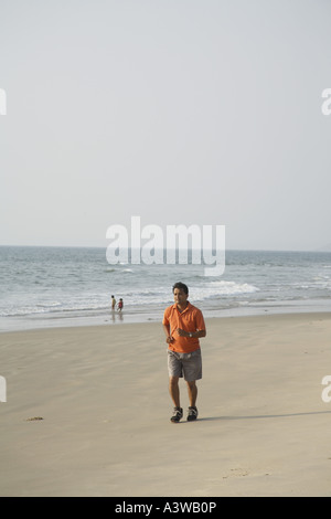 Young man jogging in the morning outdoor on the running race track ...