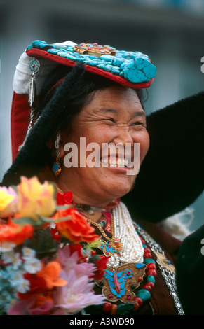 Smiling old Ladakhi woman in traditional dress and hat Leh Ladakh India ...
