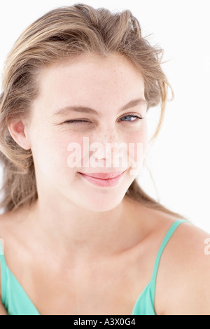 Mischievous smile. Portrait of a pretty woman on a white background ...