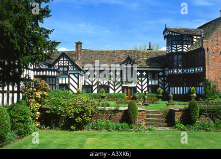 Gawsworth Old Hall, England. Summer view of a red rose in bloom with ...