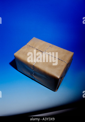 The box is wrapped with rope, the parcel is on a rustic background ...
