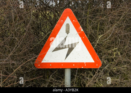 Road sign warning of overhead power lines danger. Electrical ...
