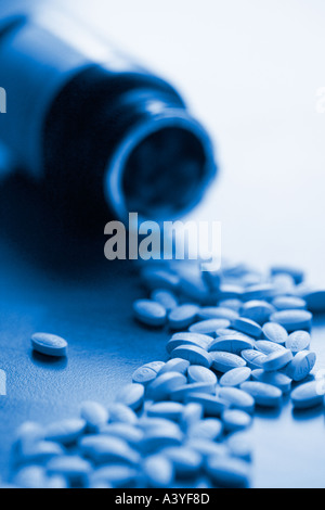 little blue pills tablets medication Stock Photo - Alamy