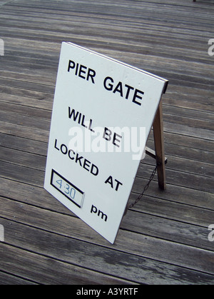 pier closing time notice Stock Photo - Alamy