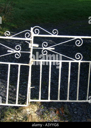 wrought iron gate with sun breaking through Stock Photo - Alamy