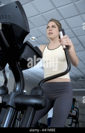 Sport woman working out on elliptical trainer in gym Stock Photo - Alamy