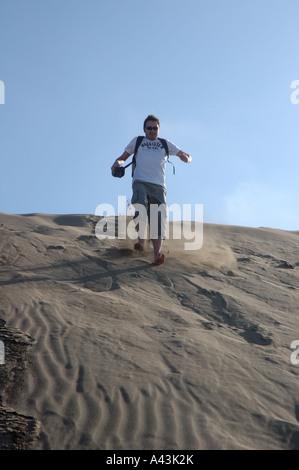Lone man running on the sand through sandy desert on the horizon. Black ...
