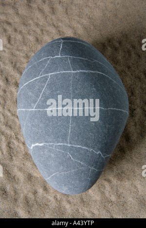 Elliptical ancient smooth stone with irregular geometric markings ...