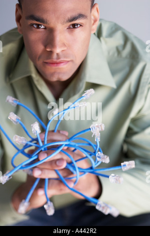 Young man holding Ethernet cables Stock Photo - Alamy
