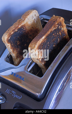 Burnt toast in toaster Stock Photo - Alamy