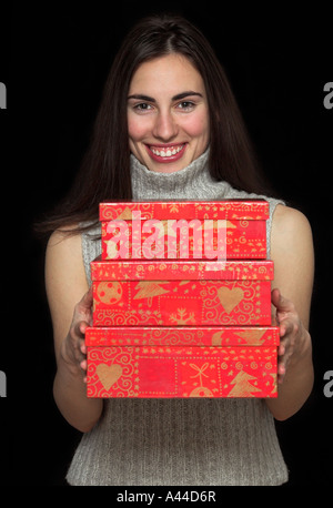 smiling woman with a gift box giving a thumbs up Stock Photo - Alamy
