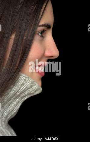side view of young beautiful woman in straw hat standing on steps on ...