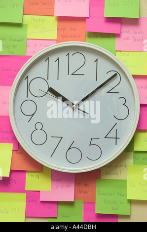 Clock surrounded by sticky notes Stock Photo - Alamy