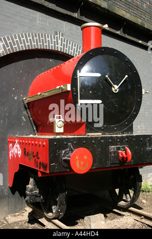 A train coming out of a tunnel The shell of an old steam train has been ...
