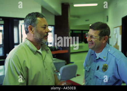Correctional Officer talking to inmate Stock Photo - Alamy