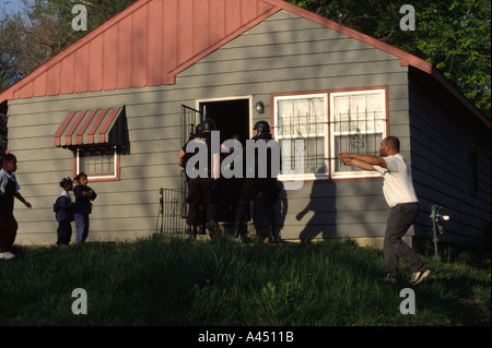 Police SWAT TAC team entering the house of a suspect to serve search ...