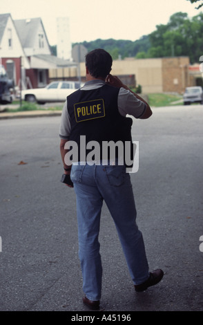 Plainclothes police sergeant using hand held radio. Kansas City, MO ...