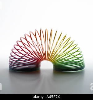bent slinky spring childs toy bendy flexible play Stock Photo - Alamy
