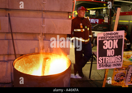 Striking firefighter on picket line outside the fire station in Stock ...