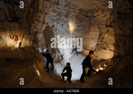A group of cavers exploring an old chalk mine in Reading Berkshire ...