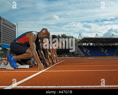 Side profile of male runners at the starting line Stock Photo - Alamy