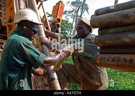 Exploration core drilling, showing offsiders and driller with rig in ...