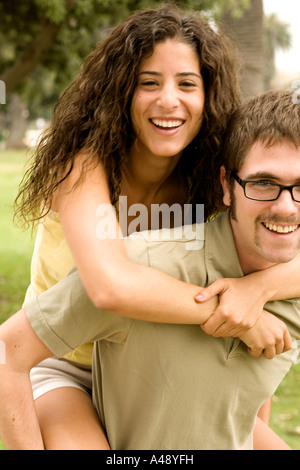 Portrait of a cheerful young man and woman in love, laughing and ...
