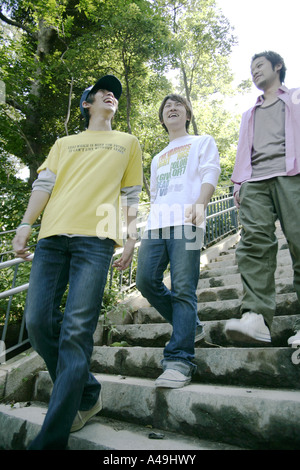 Three young men walking down steps Stock Photo - Alamy