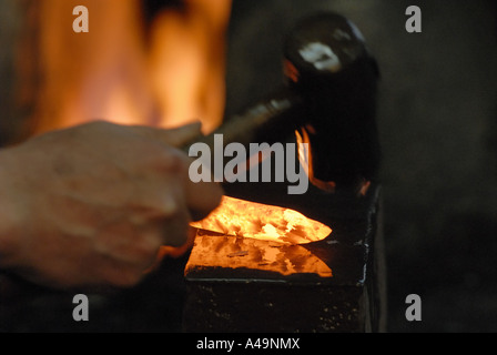 Close up of a heated iron rod on an anvil Stock Photo - Alamy