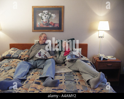 A woman holding up a dog next to cherry blossom trees on January 29 ...
