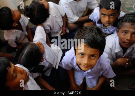 Group of indian village students in school uniform sitting in classroom ...