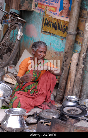 Stock image of portrait of old Dalit woman carrying basket in slum in ...