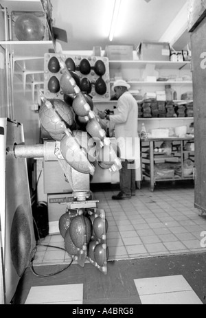 Making chocolate. Making chocolate easter eggs. Chocolate factory Stock ...