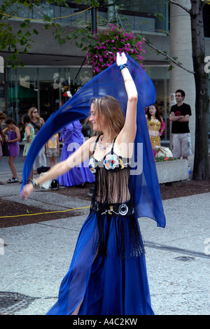 A dancer performing street belly dancing at Farol da Barra square in ...