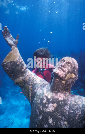 A FEMALE SCUBA DIVER AT THE STATUE OF CHRIST OF THE ABYSS IN KEY LARGO ...