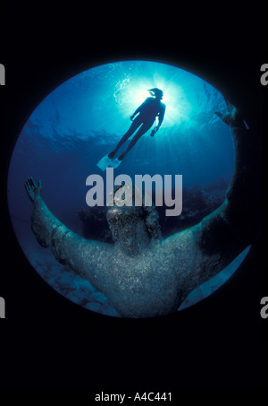A FEMALE SCUBA DIVER AT THE STATUE OF CHRIST OF THE ABYSS IN KEY LARGO ...