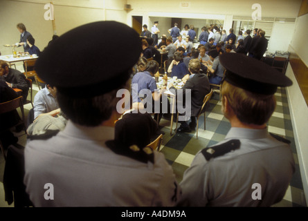 Prison officers watch over a prisoner toeing the line during an ...