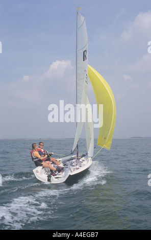man and woman in RS200 sailing dinghy passing Craigleith island off ...