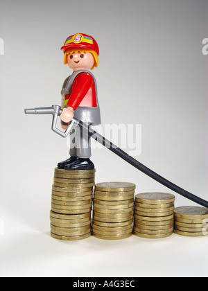 Service station attendant on a pile euro coins as symbol for the rising ...