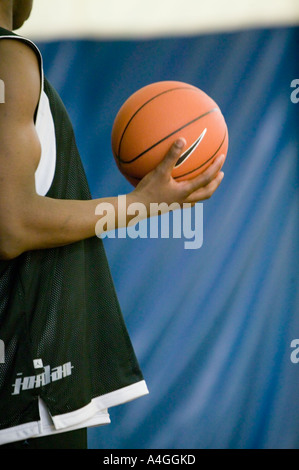 African American man holds a basketball in a gym Stock Photo - Alamy