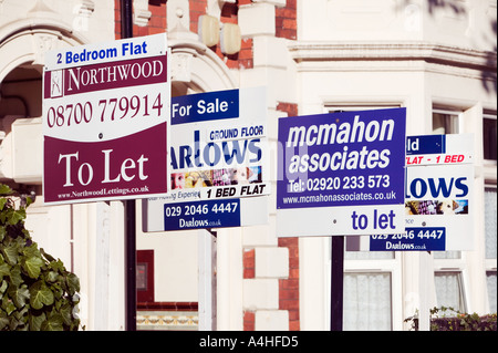 ESTATE AGENT SIGNS OUTSIDE HOUSES FOR RENT AND SALE IN THE LONDON ...