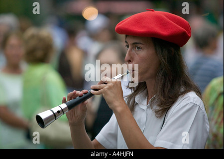 Basque woman in red txapela playing wind instrument, Our Lady of Begoña ...