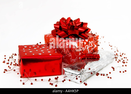 Christmas parcels wrapped in red and green paper with ribbons and bows ...
