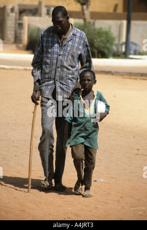 Boy Leading Blind Man, Niger Stock Photo - Alamy